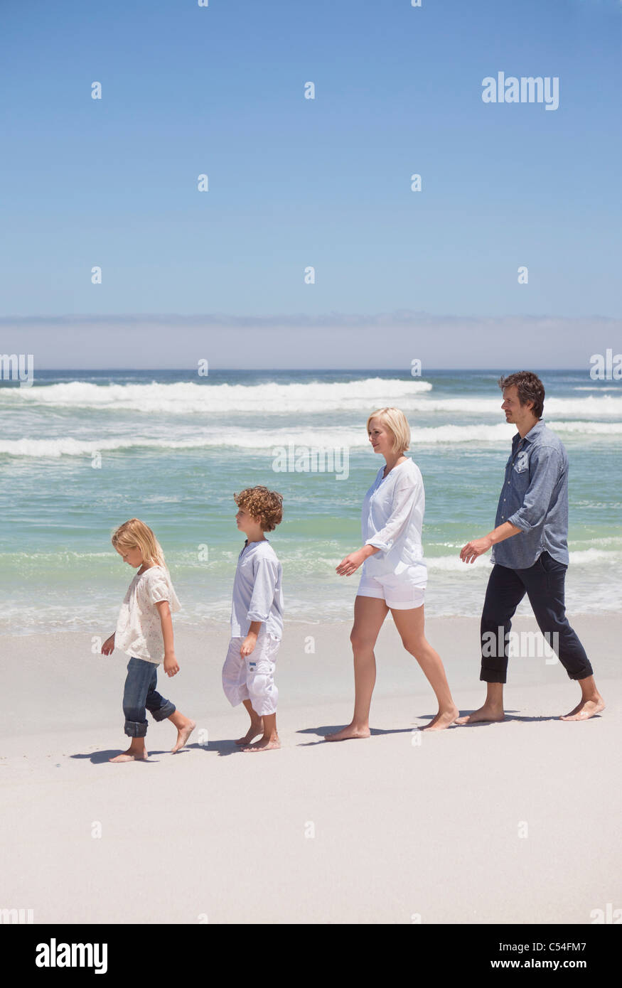 People walking on the beach Stock Photo - Alamy