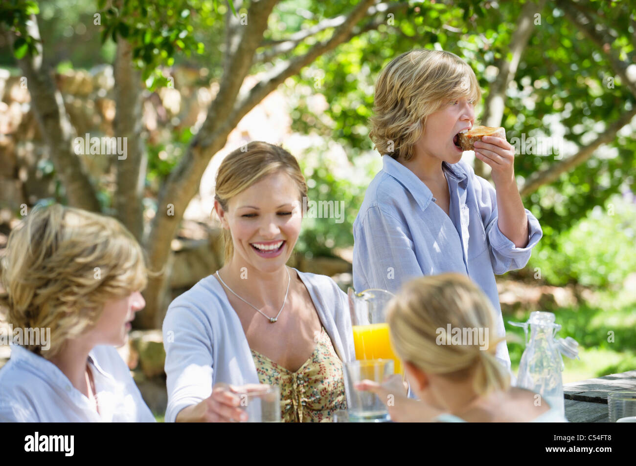 Family having food at front or back yard Stock Photo - Alamy