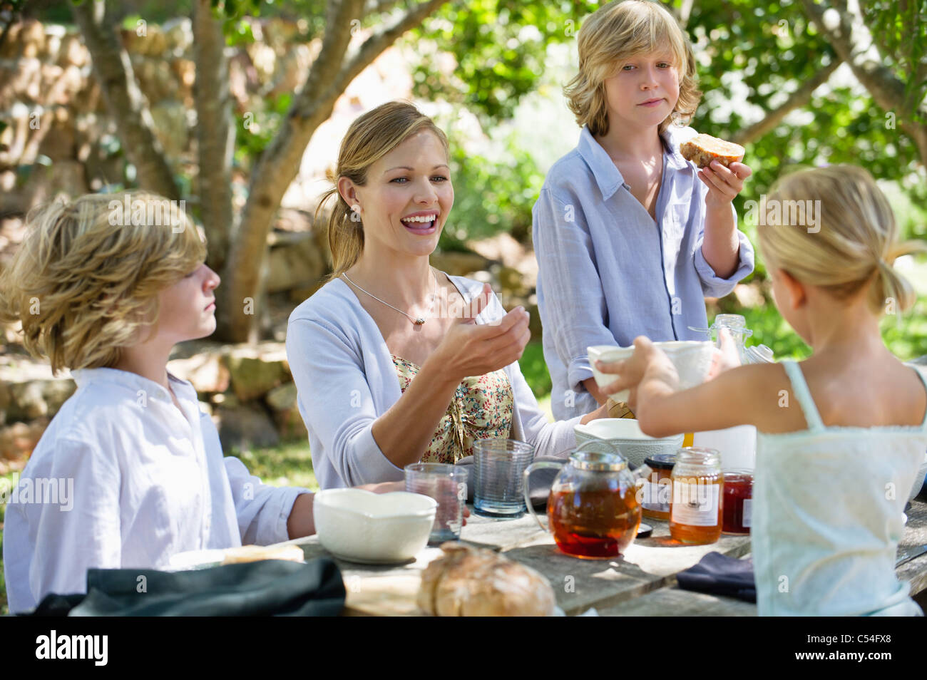 Family having food at front or back yard Stock Photo - Alamy