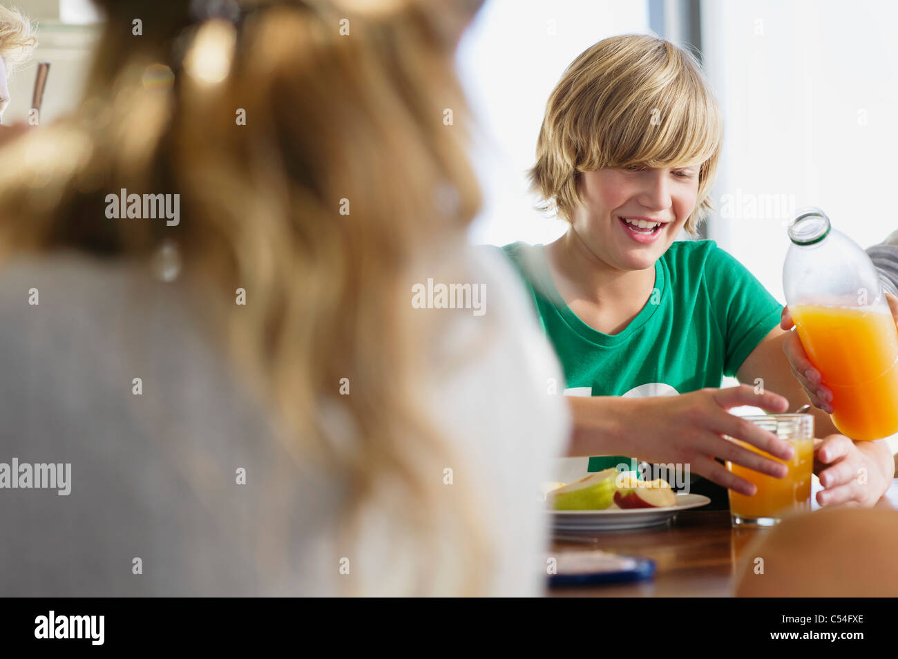 Teenage boy having breakfast at a dining table Stock Photo - Alamy