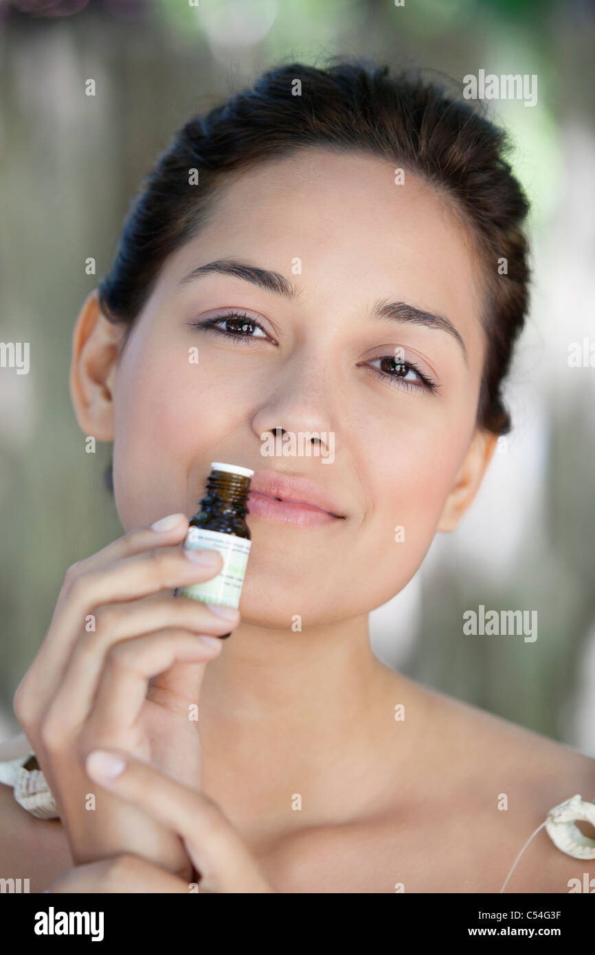 Portrait of a beautiful young woman smelling aromatherapy oil Stock ...