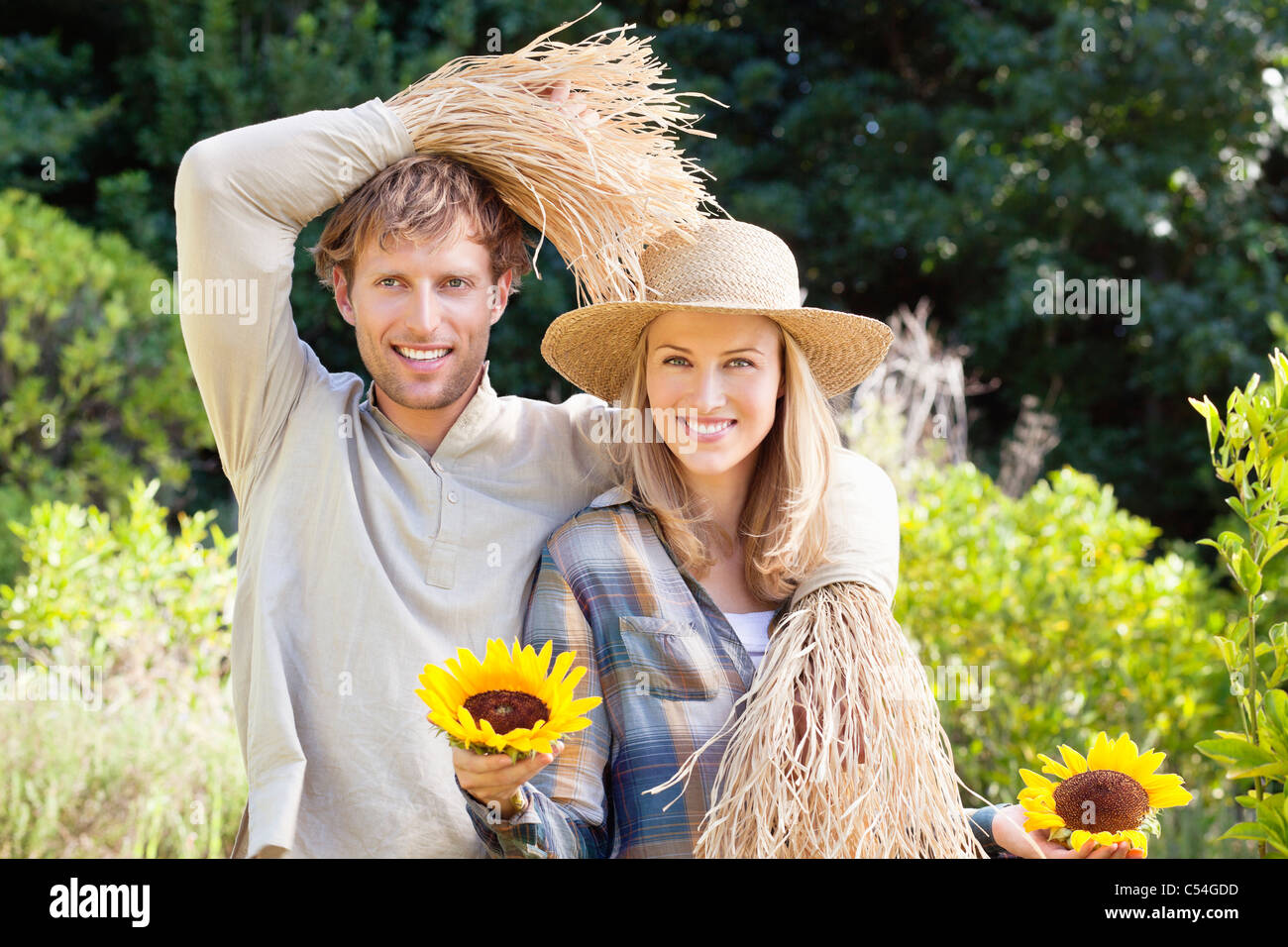 Portrait of a couple in scarecrow pose in a field Stock Photo - Alamy