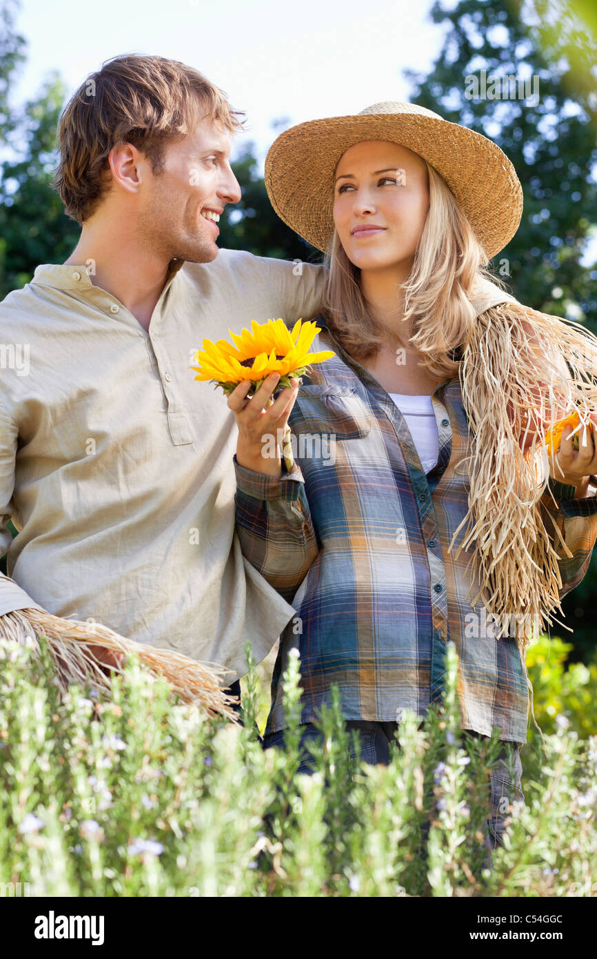 Young couple in scarecrow pose in a field Stock Photo - Alamy