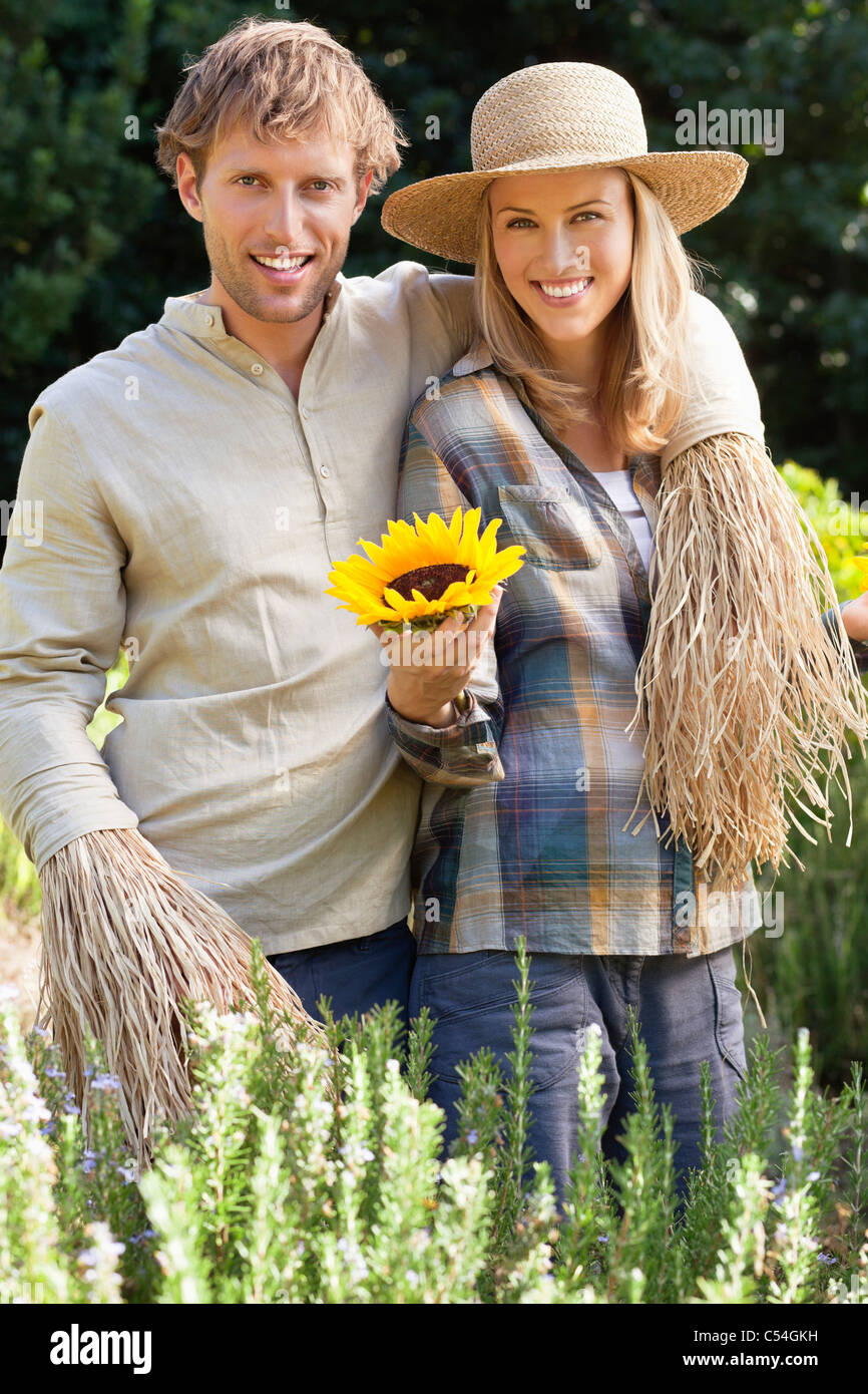 Portrait of a couple in scarecrow pose in a field Stock Photo - Alamy
