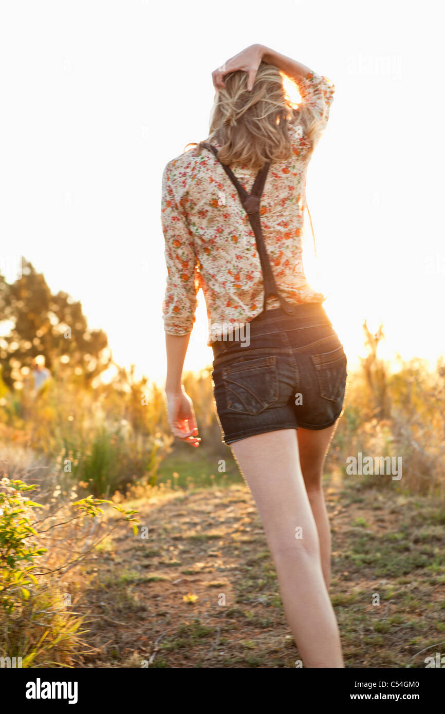 Rear view of a woman walking on a trail Stock Photo - Alamy