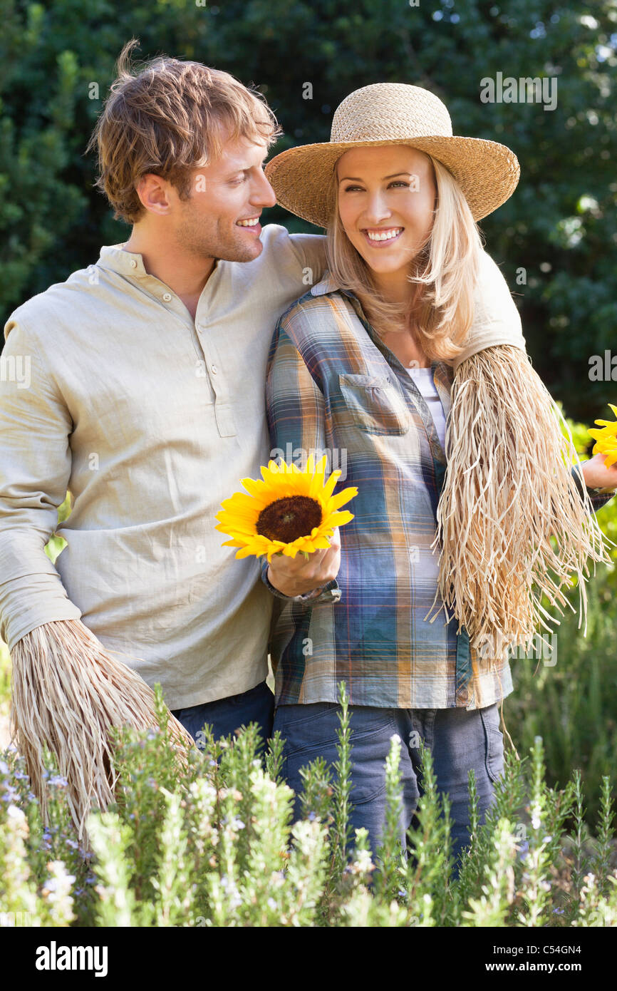 Young couple in scarecrow pose in a field Stock Photo - Alamy