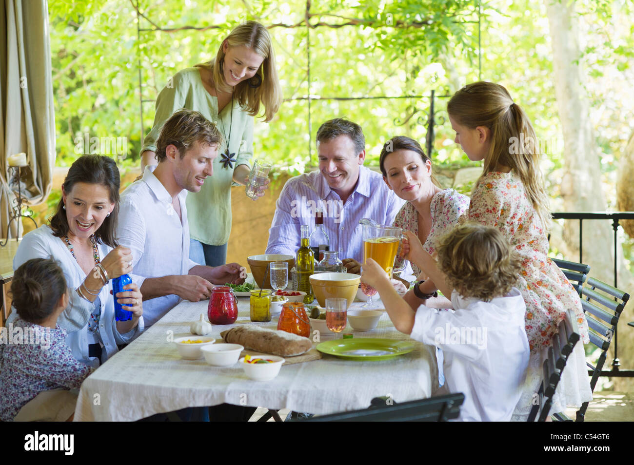 Multi generation family eating food at house Stock Photo - Alamy