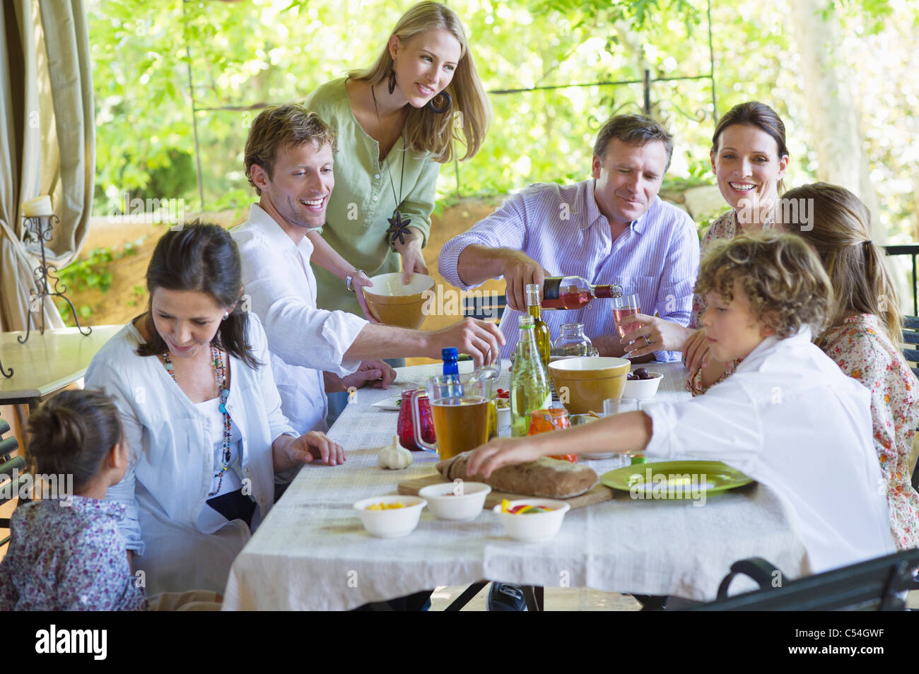 Multi generation family eating food at house Stock Photo - Alamy