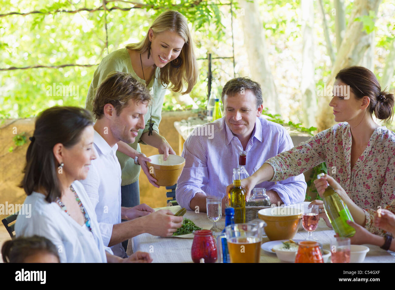 Multi generation family eating food at house Stock Photo - Alamy