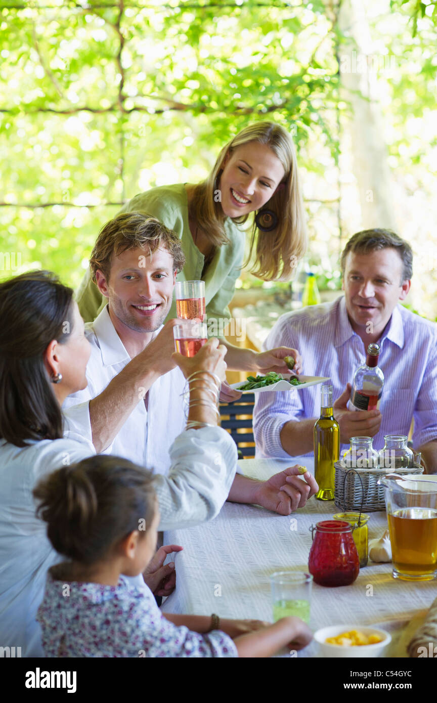 Happy family having drink at house Stock Photo - Alamy