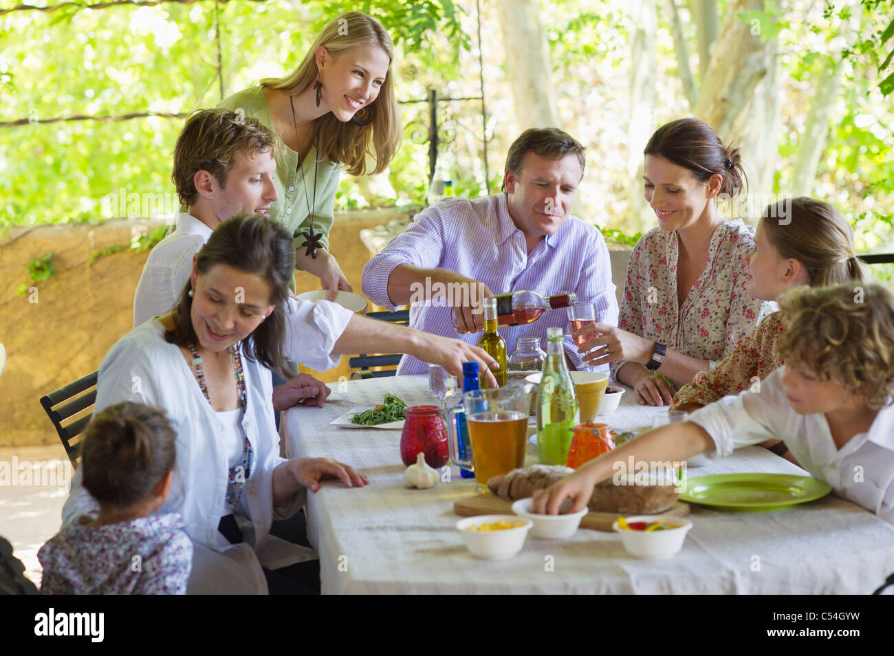 Multi generation family eating food at house Stock Photo - Alamy