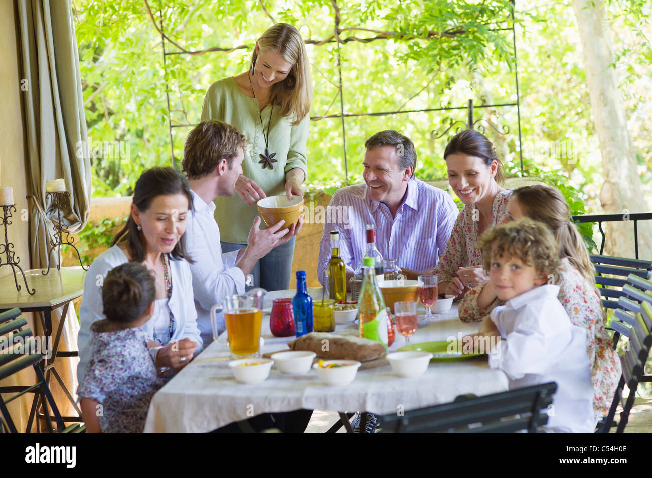 Multi generation family eating food at house Stock Photo - Alamy