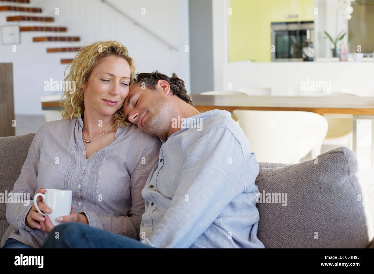 Man resting his head on a woman's shoulders Stock Photo - Alamy