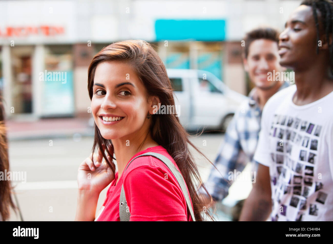 Smiling friends walking together Stock Photo - Alamy