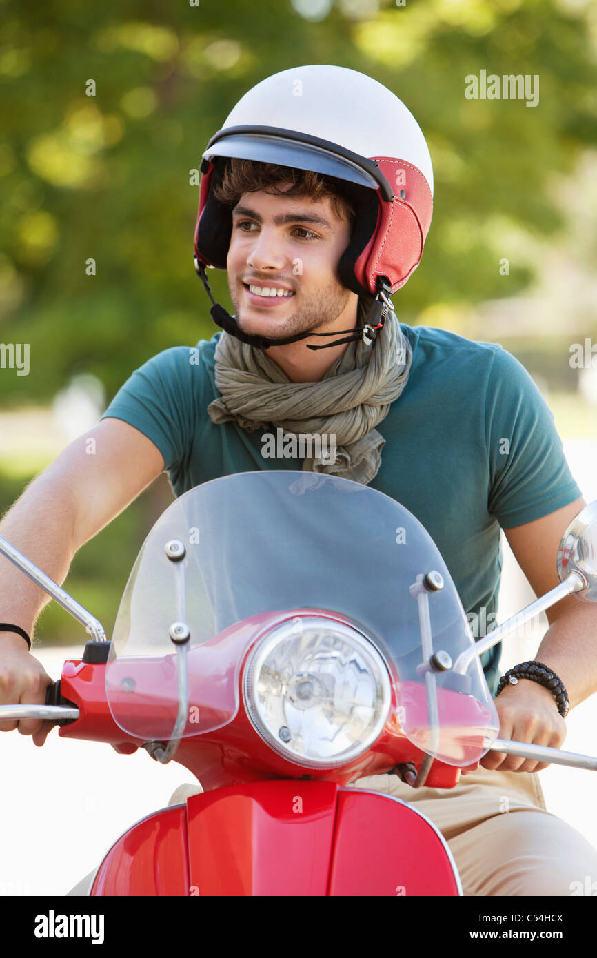 Man riding a scooter Stock Photo - Alamy