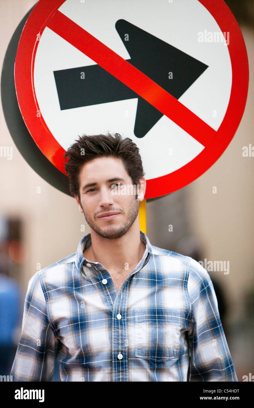 Handsome man smiling with no entry sign in the background Stock Photo ...
