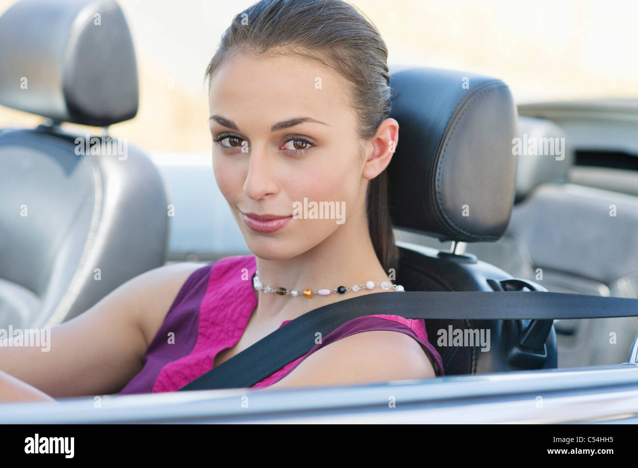 Portrait of a beautiful young woman driving a convertible car Stock ...