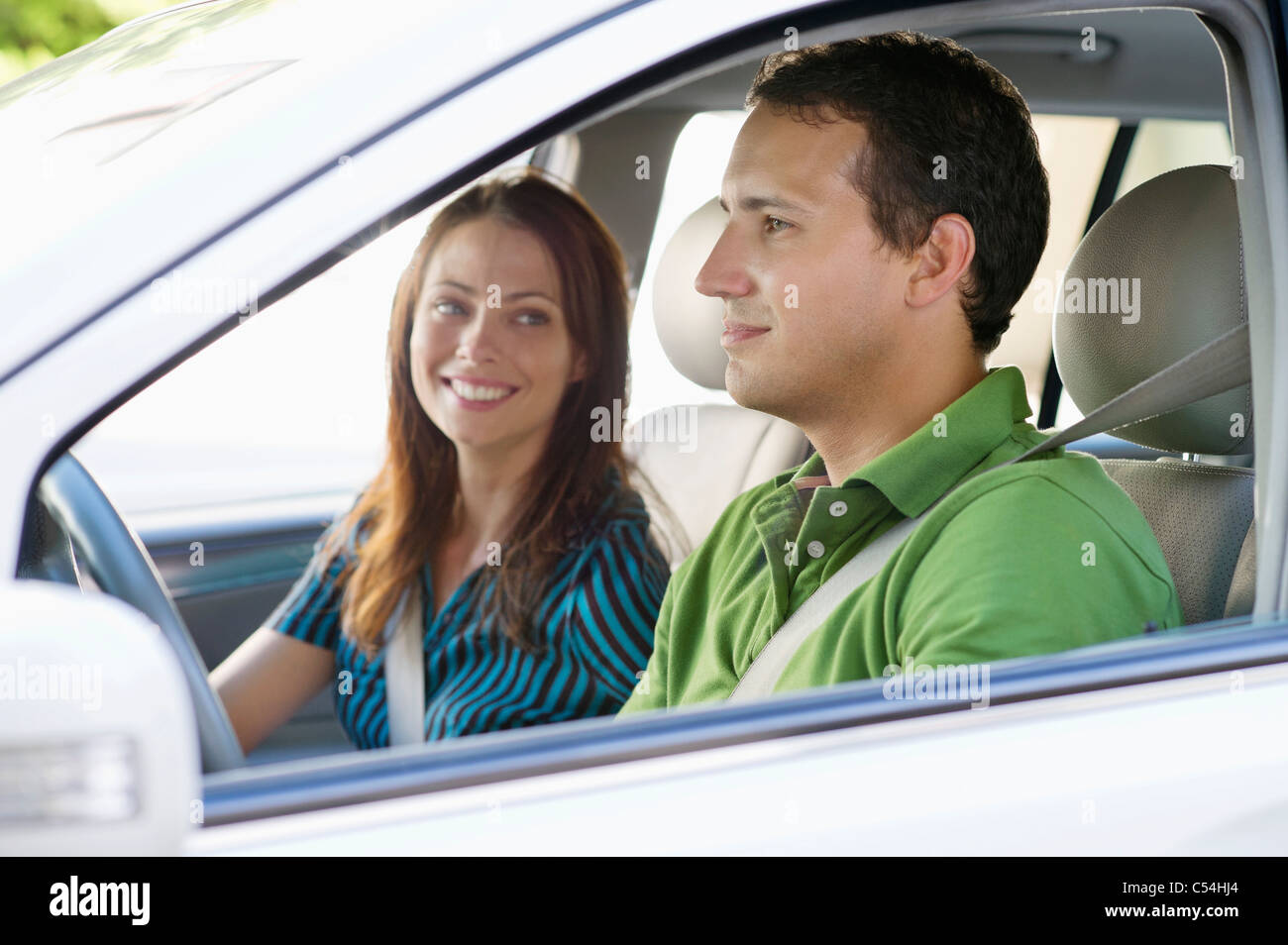 Happy couple driving a car Stock Photo - Alamy