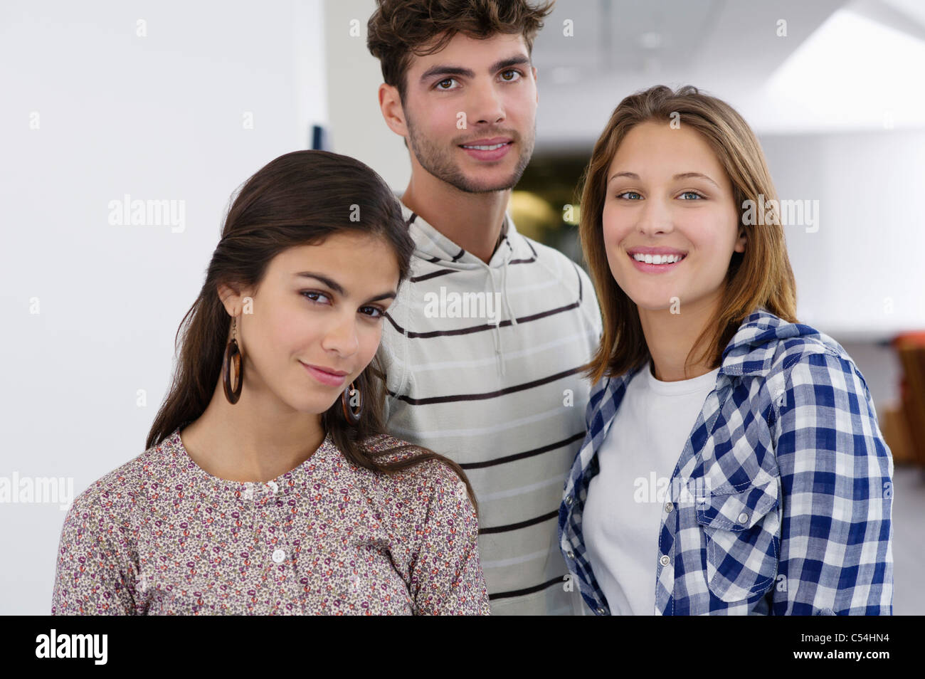 Portrait of three young friends standing together Stock Photo - Alamy