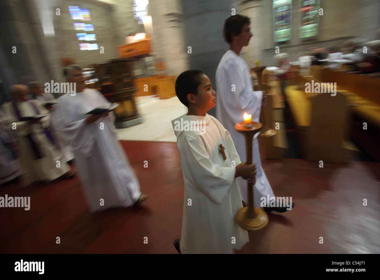 A boy carries a candle into Sunday Service at Nelson's Christ Church ...