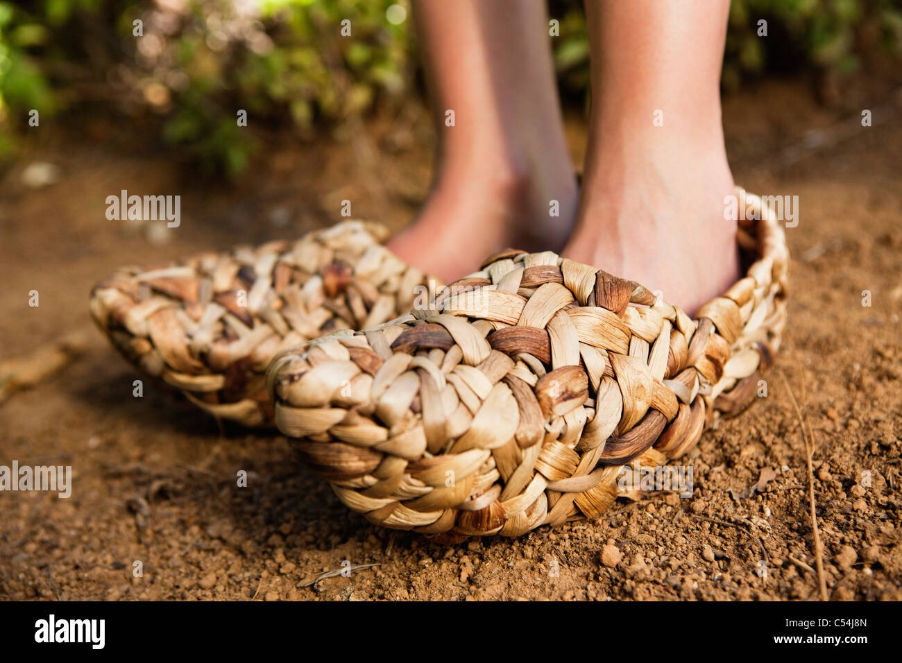 Low section view of a woman wearing wicker shoe Stock Photo - Alamy