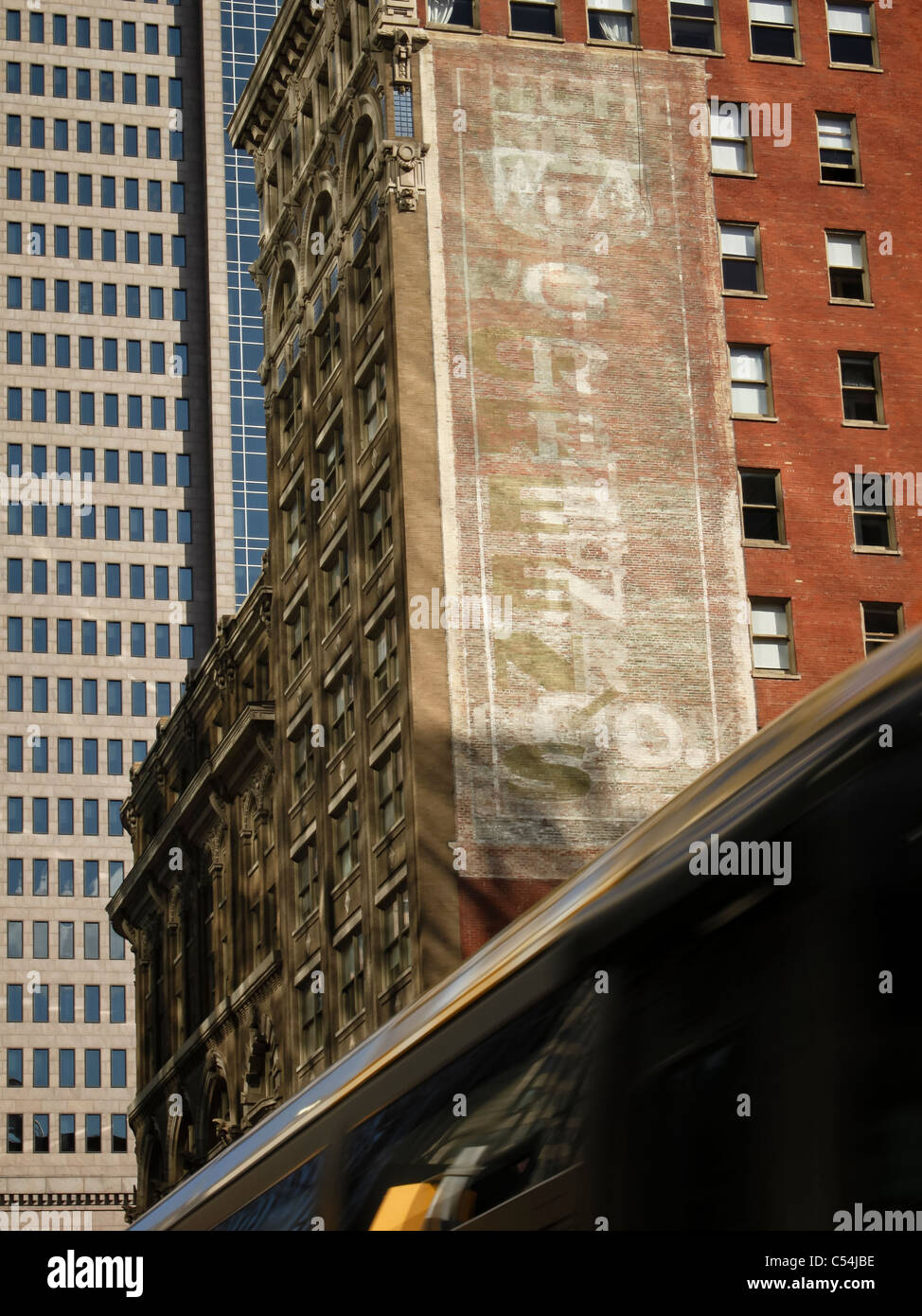 Blur of a public transportation bus driving in front of two juxtaposed ...