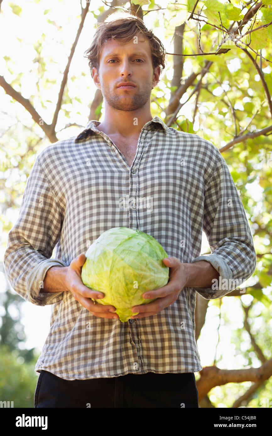 Portrait of a man holding a cabbage Stock Photo - Alamy