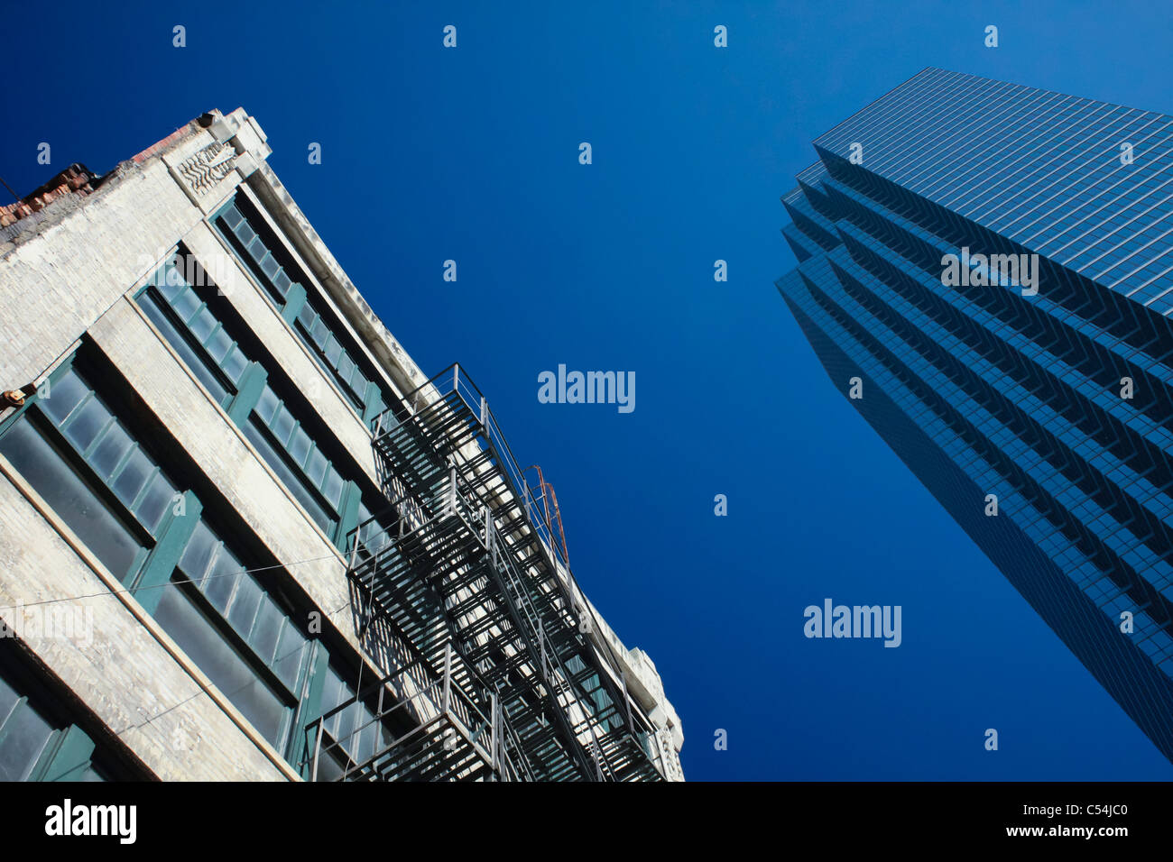 Old building in sharp contrast against a modern glass skyscraper Stock ...