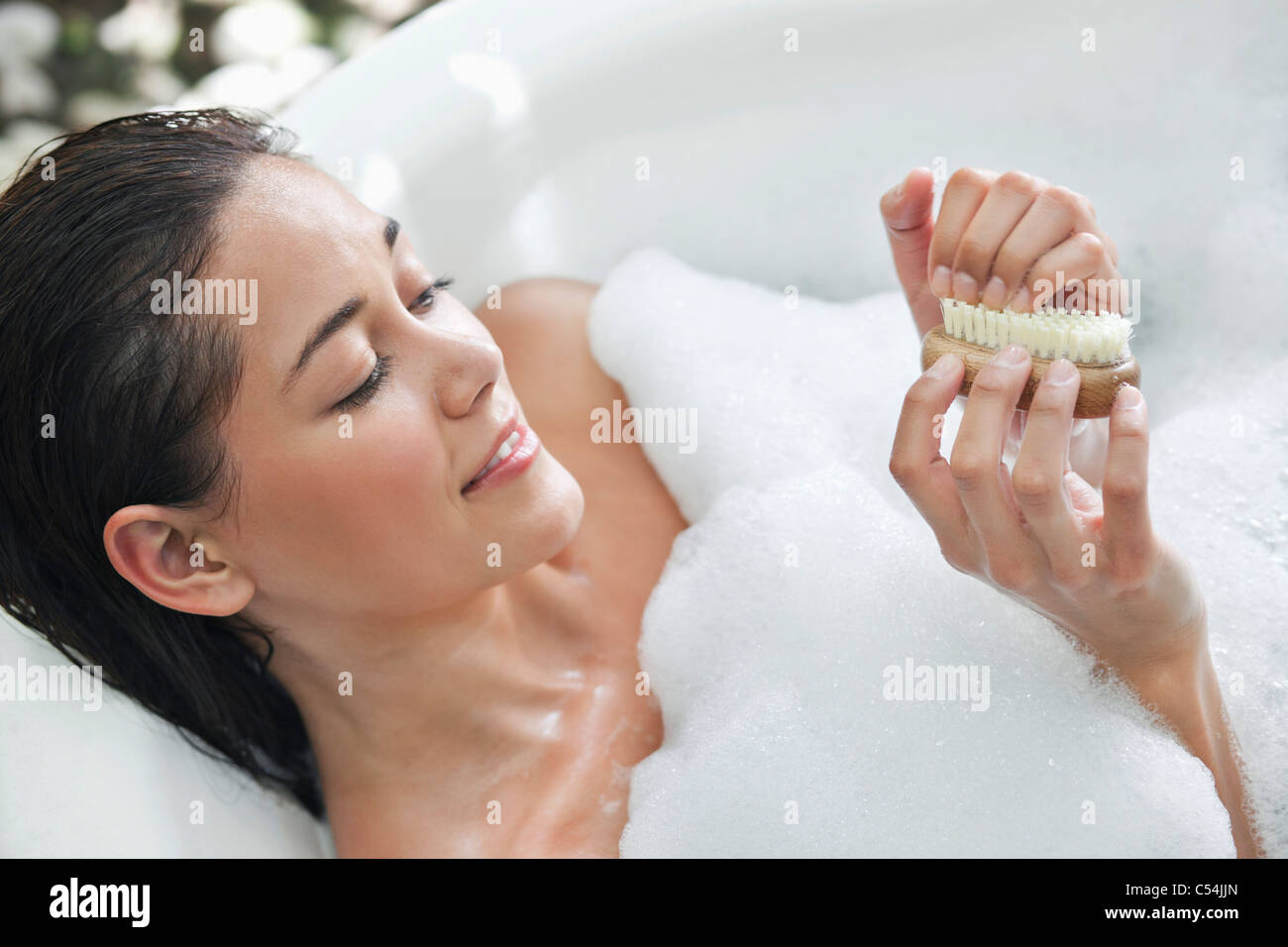 Beautiful young woman taking bubble bath Stock Photo - Alamy