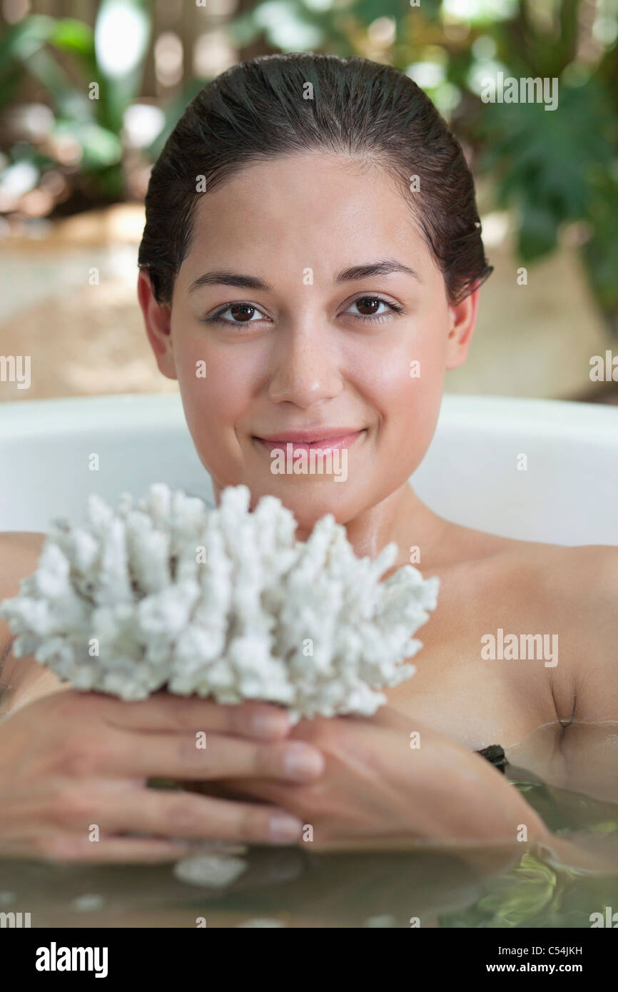 Portrait Of A Beautiful Young Woman Holding Bath Sponge In A Bathtub