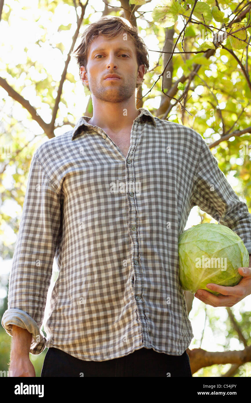 Portrait of a man holding a cabbage Stock Photo - Alamy