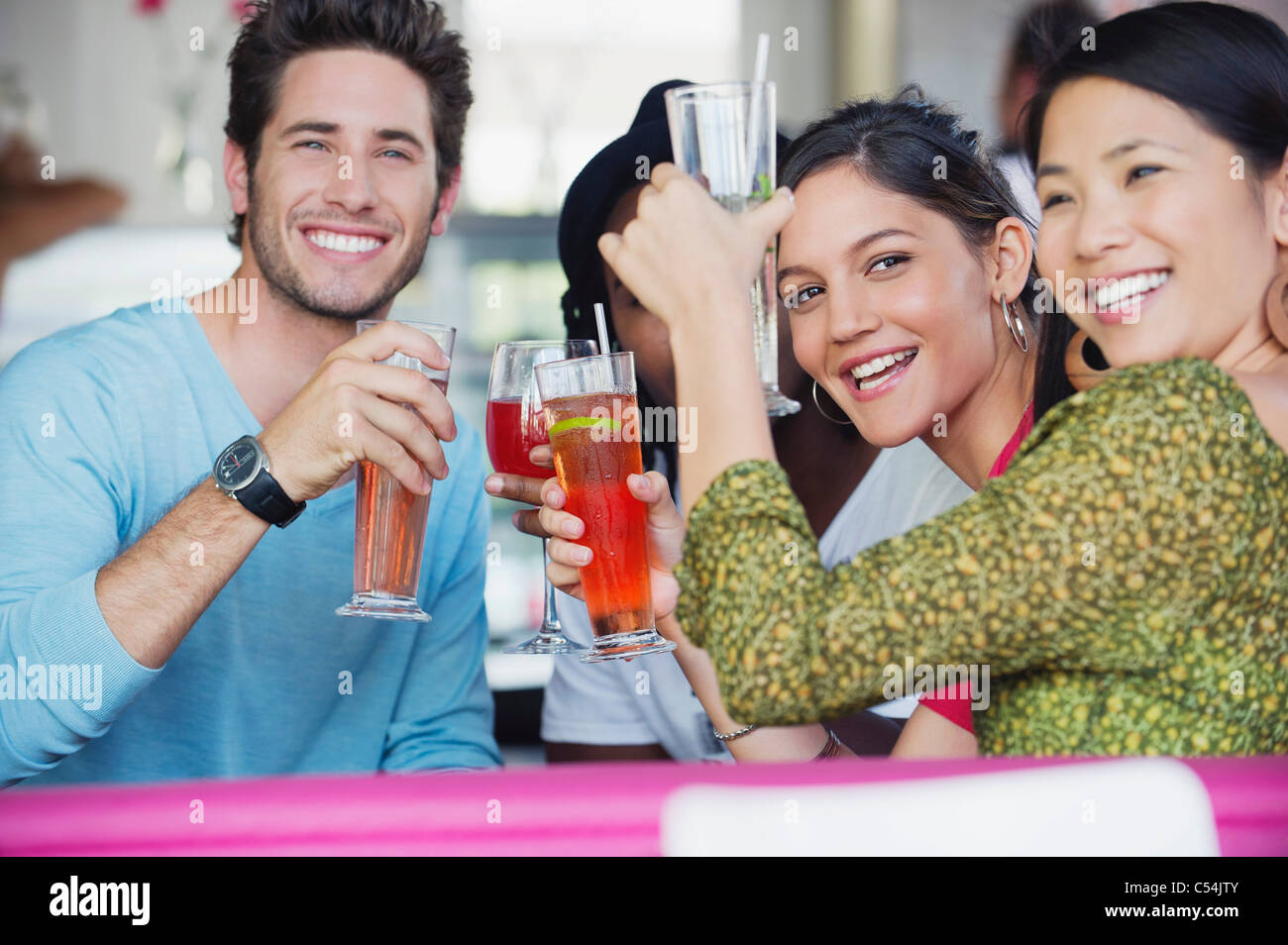 Portrait of friends toasting drinks in a restaurant Stock Photo - Alamy