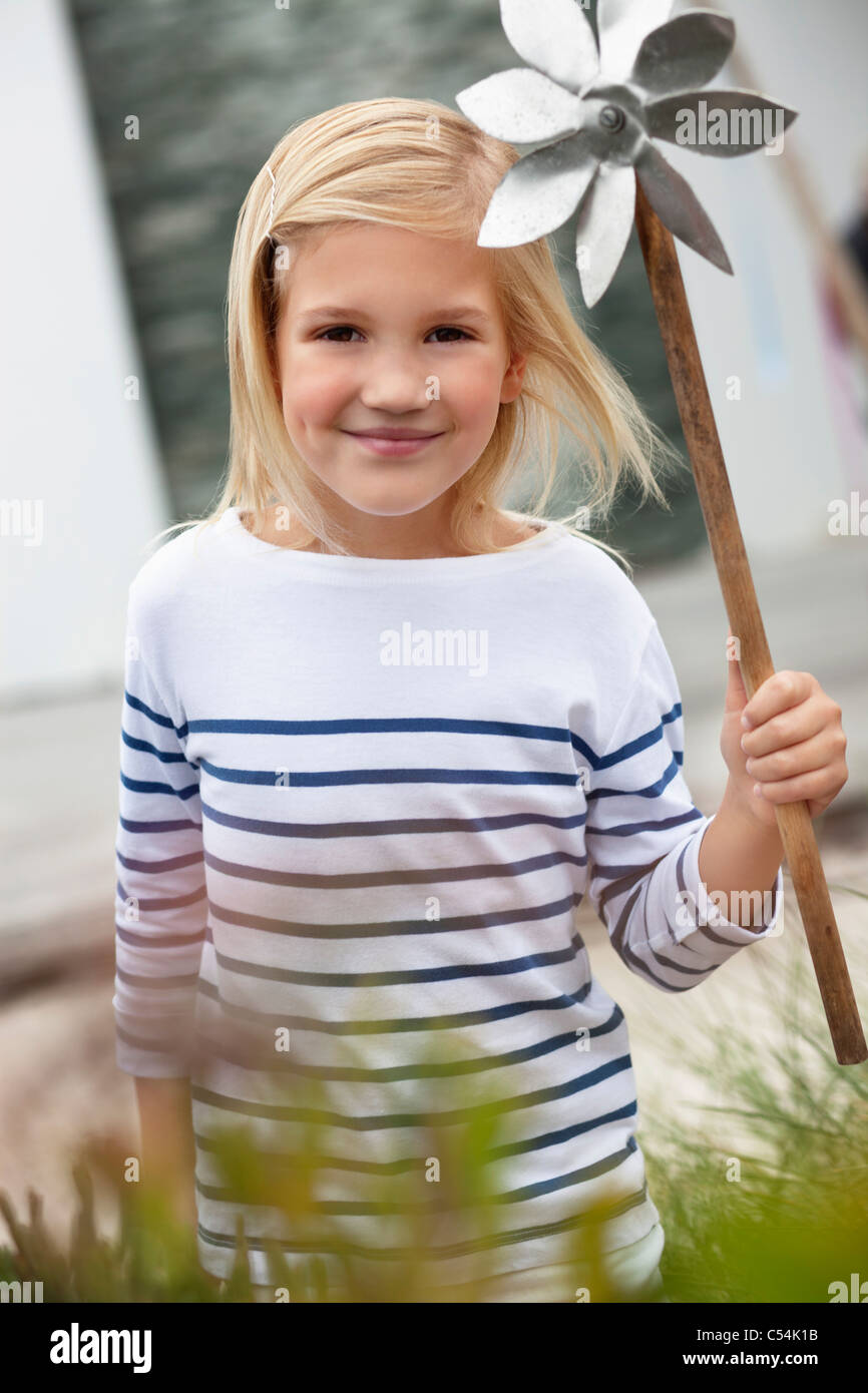 Cute girl holding pinwheel Stock Photo - Alamy