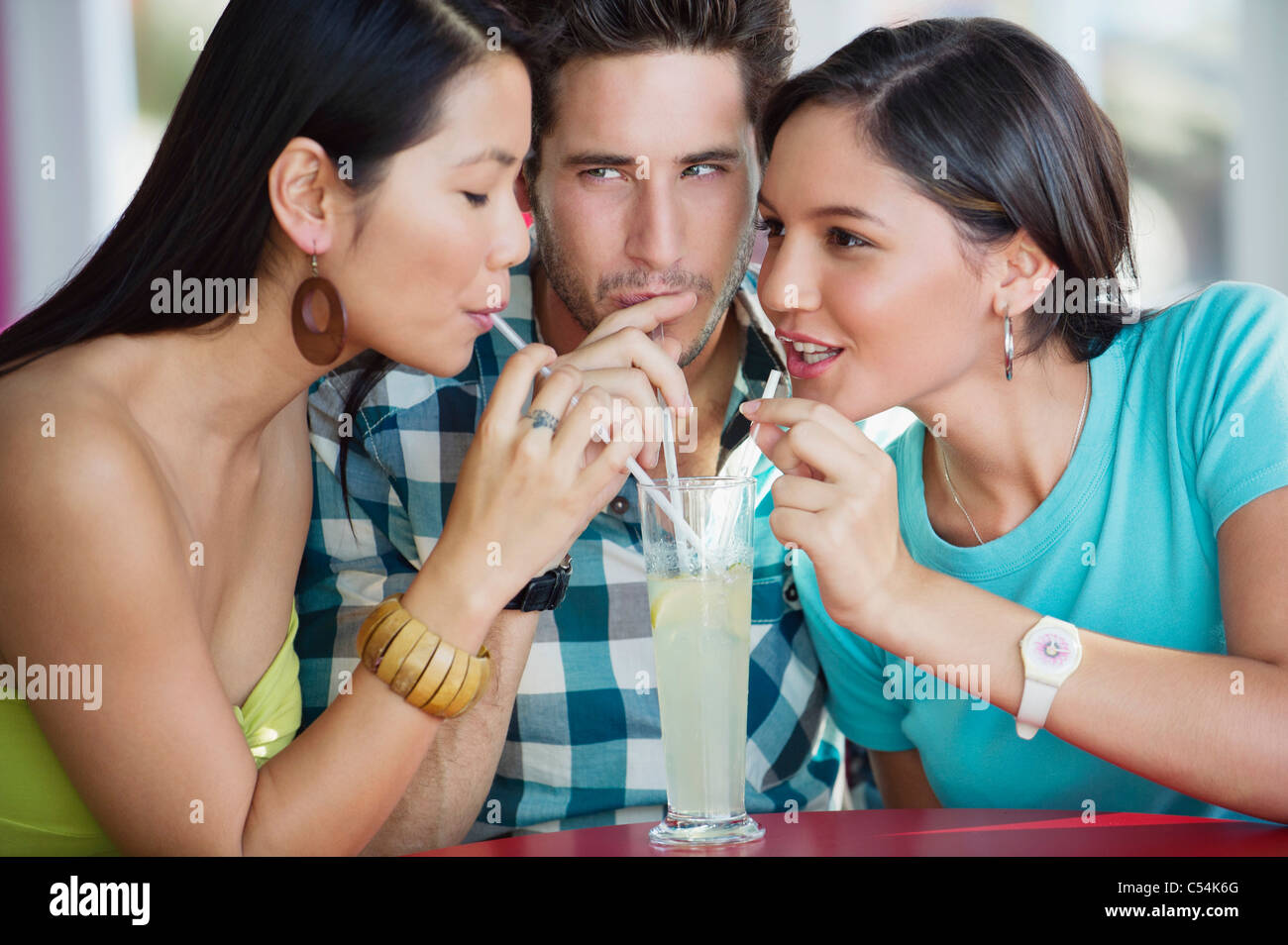 Friends sharing lime juice in a restaurant Stock Photo - Alamy