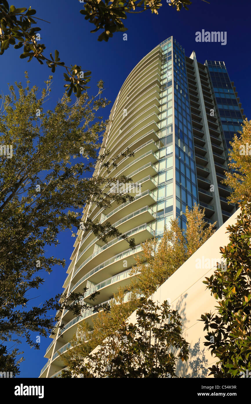 A high-end residential building shoot between trees against a deep blue ...