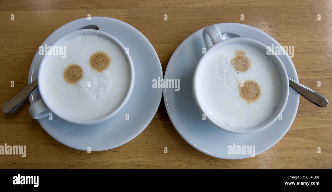 Two cups of cappuccino coffee Stock Photo - Alamy
