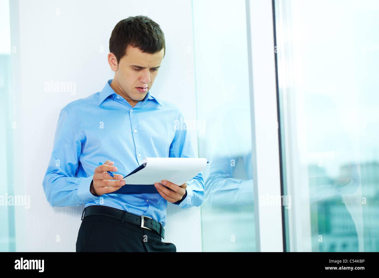 Portrait of serious man looking at his plan in office Stock Photo - Alamy