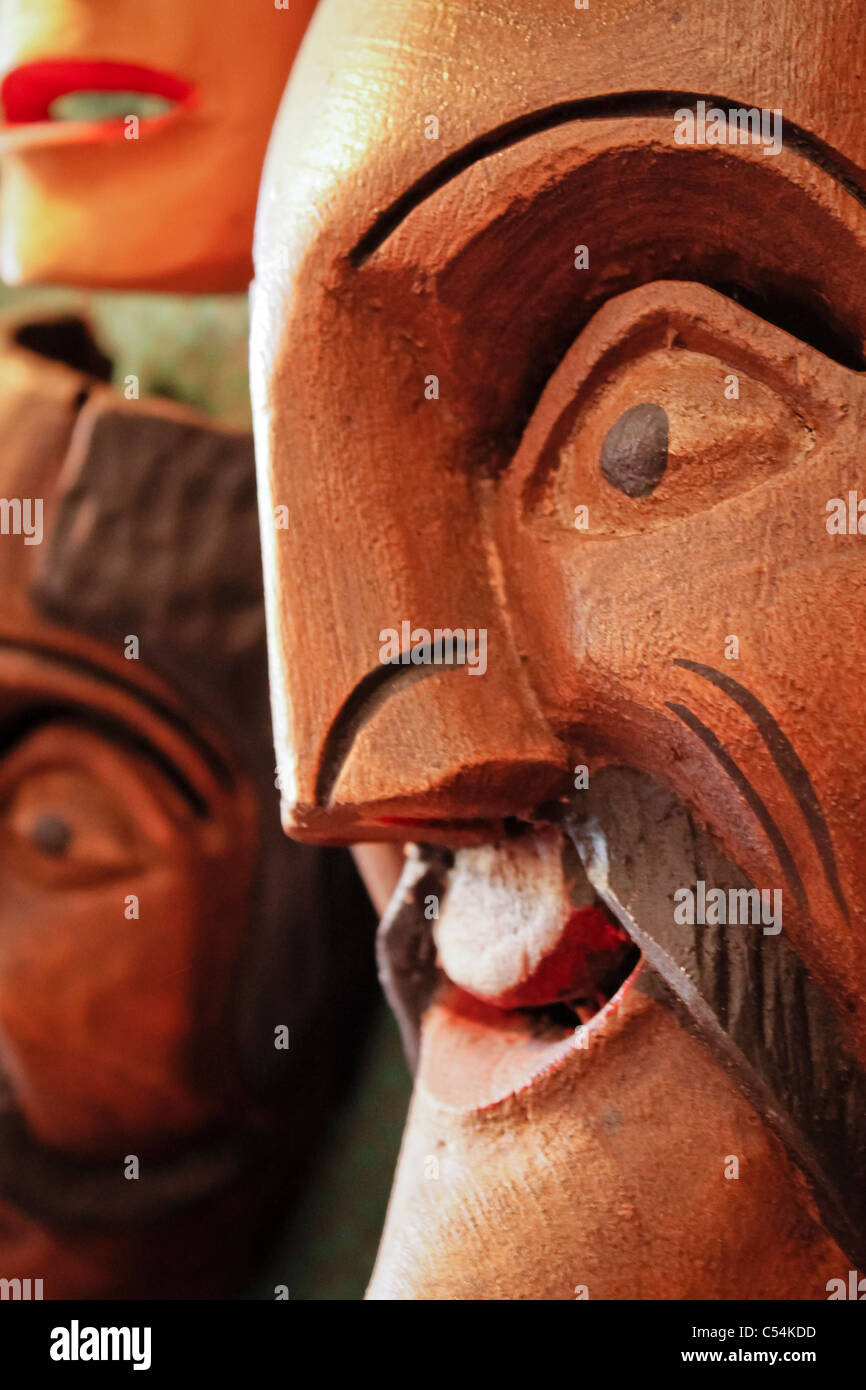 Hand-carved wooden mask of man with big mustache and expressive eyes ...