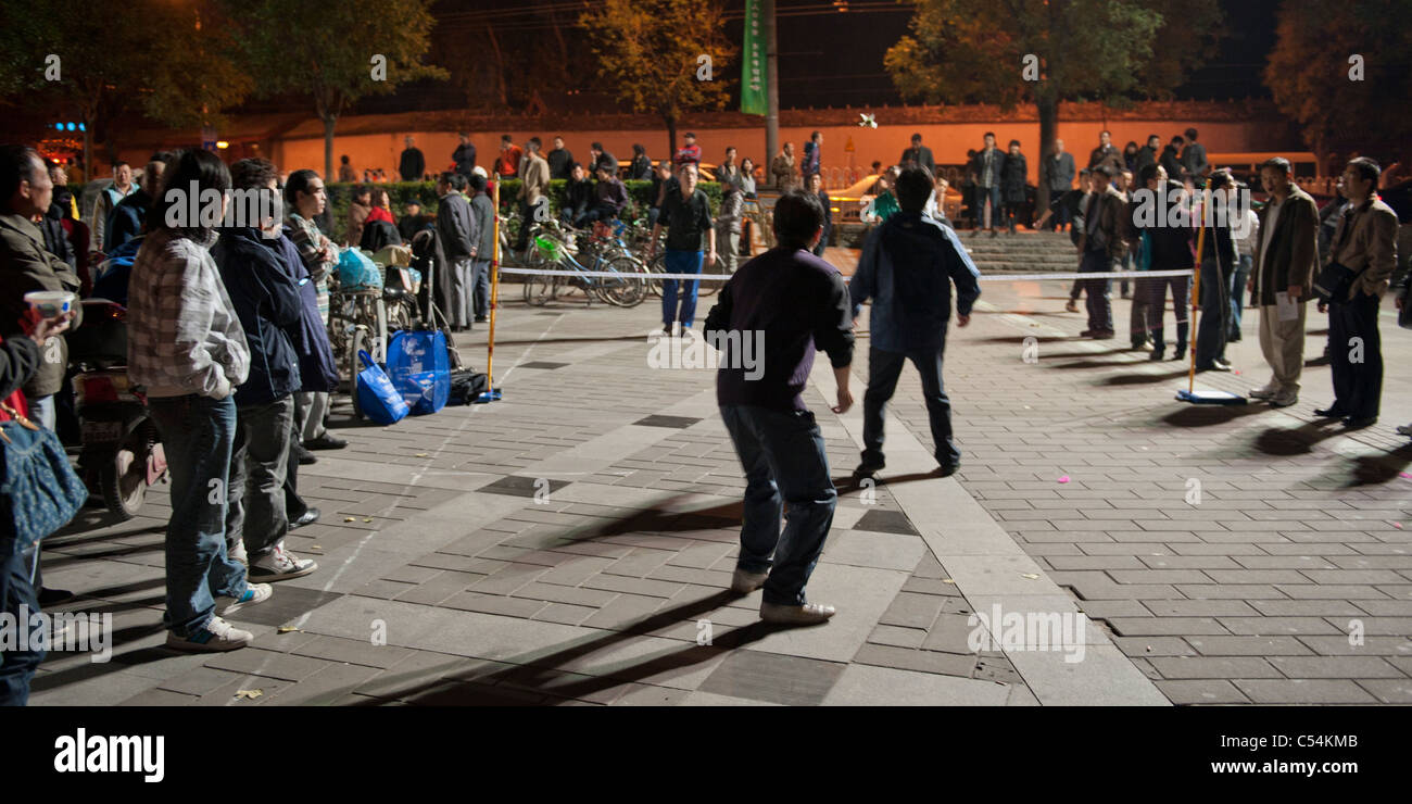 People playing feather kicker hacky sack, Back Lakes, Beijing, China ...