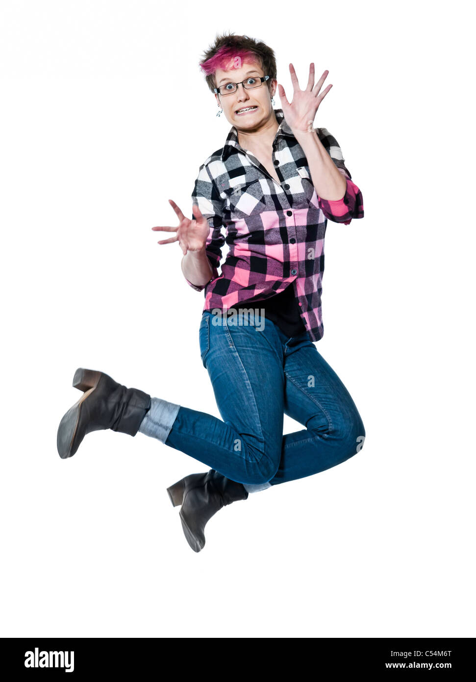 Full length portrait of an extreme nervous woman jumping in studio on ...