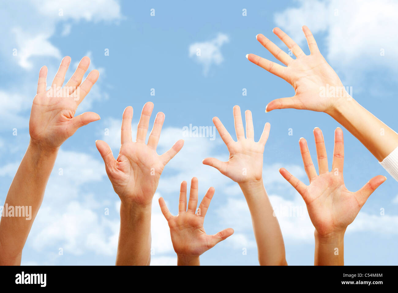 Image of hands raising isolated on blue background Stock Photo - Alamy
