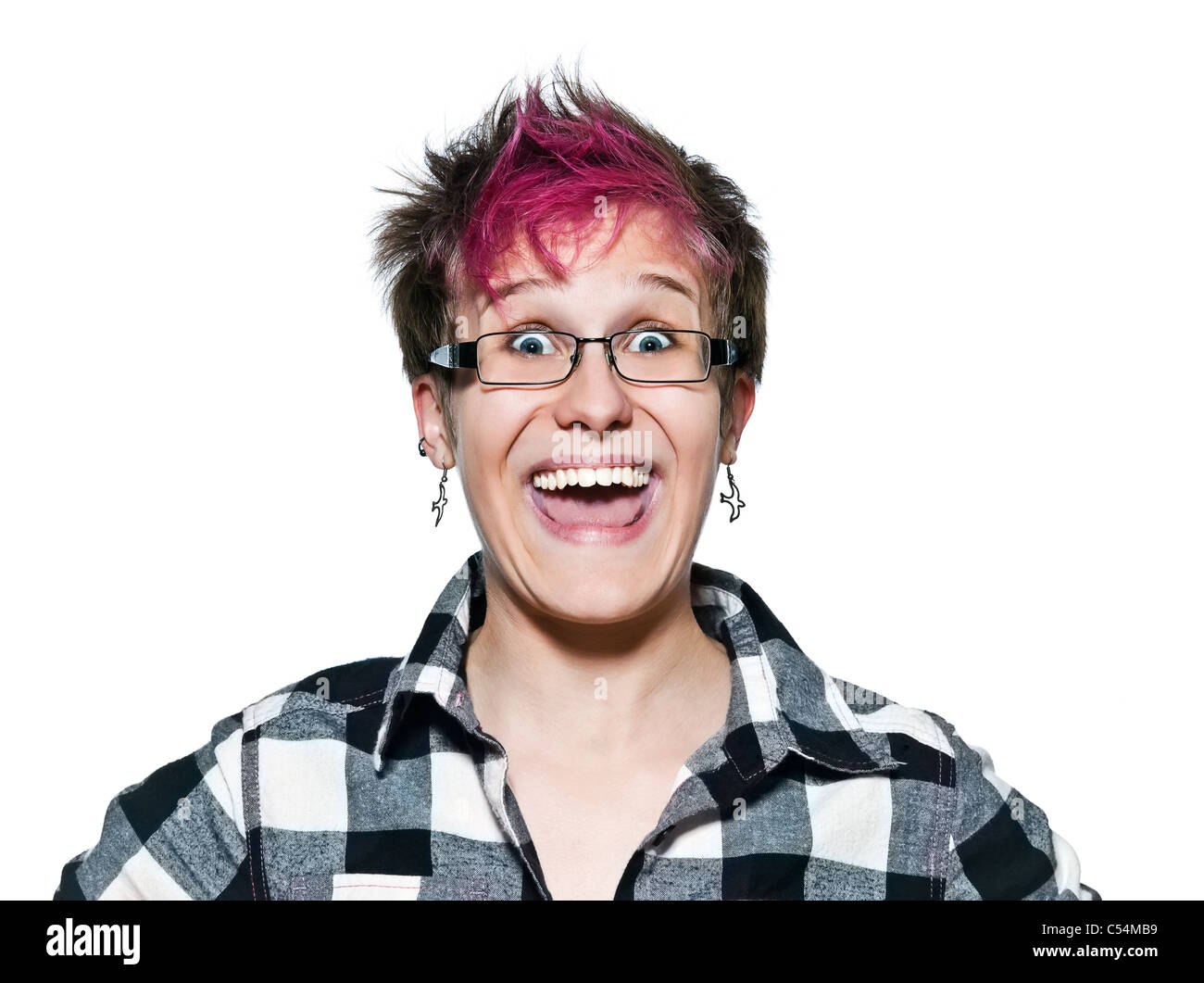 Close-up portrait of young expressive woman laughing with eyes wide open in studio on white ...