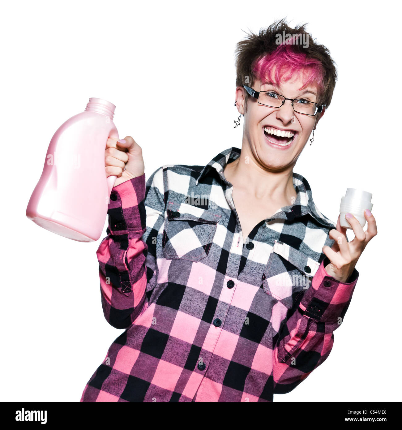 Portrait of an excited trendy young woman holding detergent in studio ...