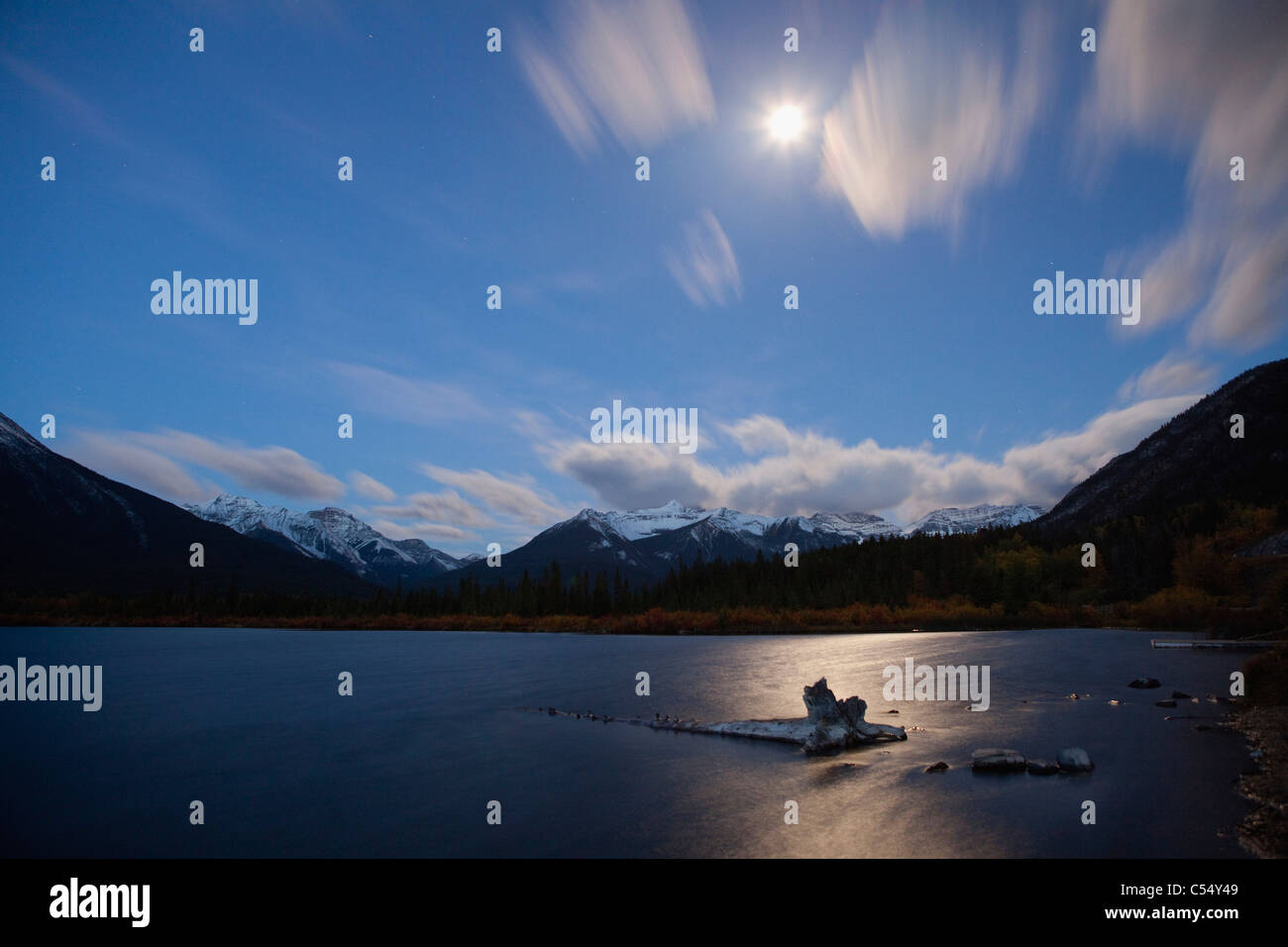 Lake surrounded with mountains at night, Mt Rundle, Banff National Park ...