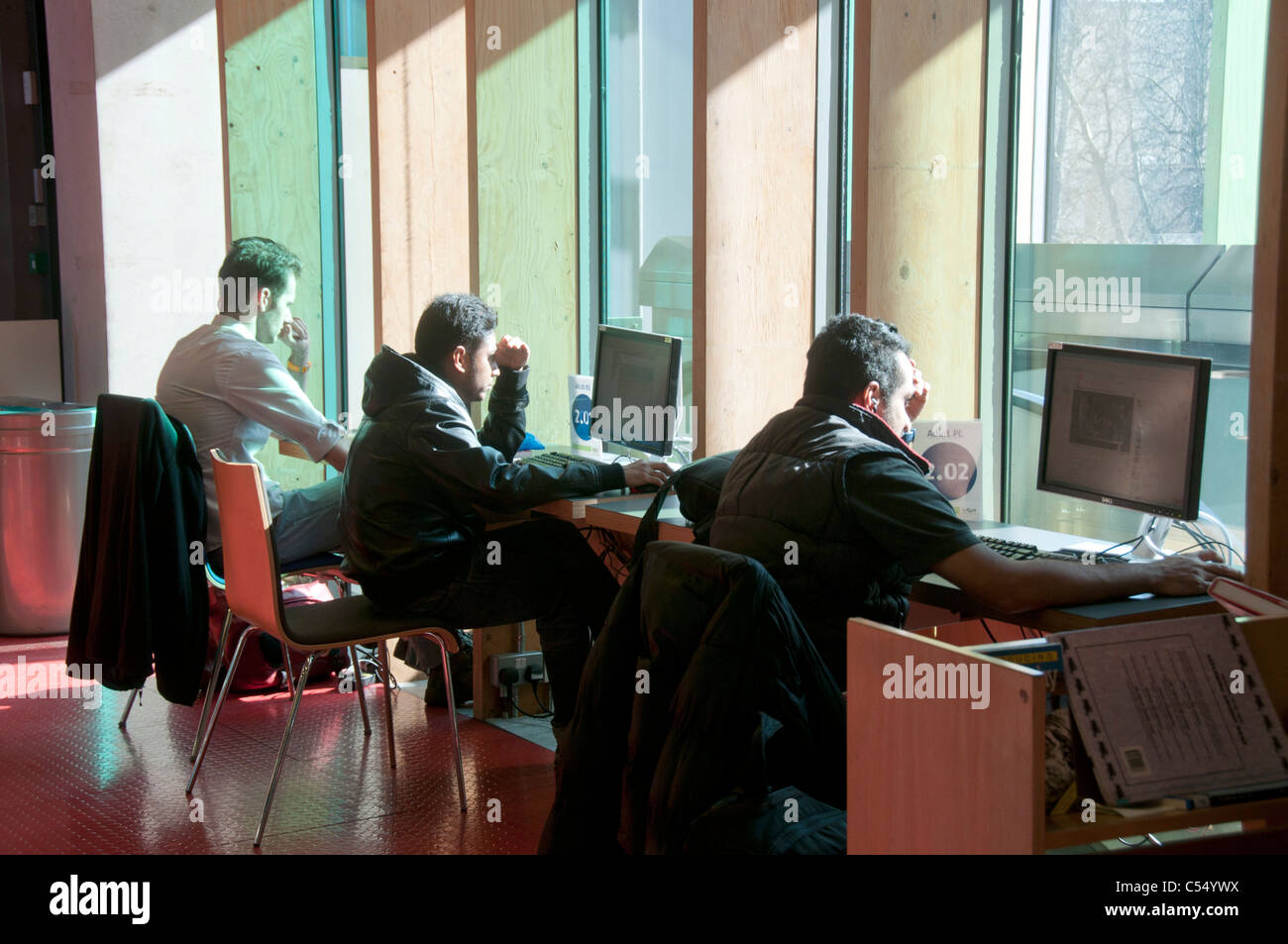 UK. Local people using computers and internet at a library in ...