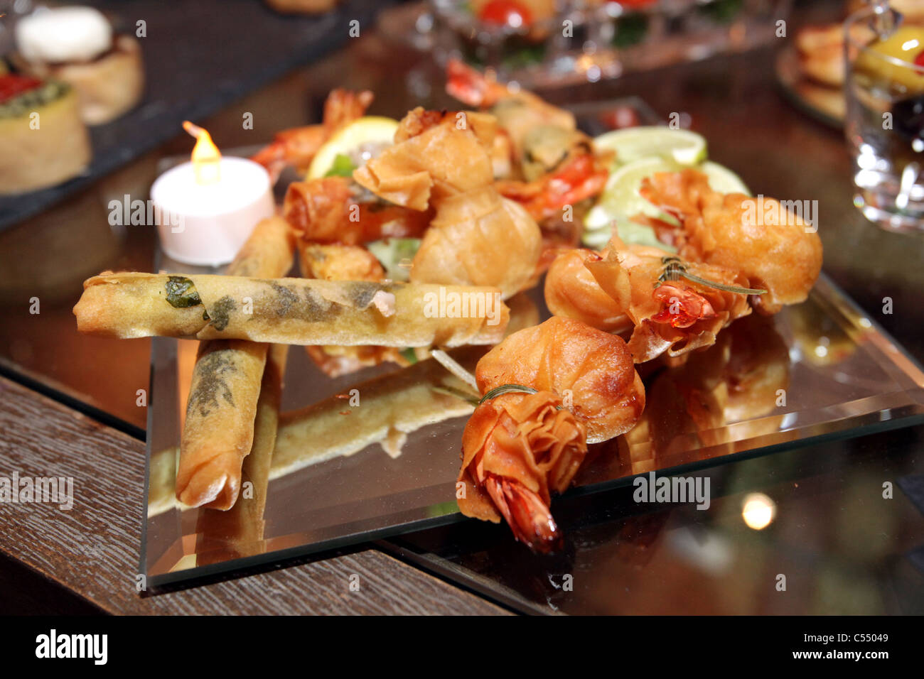 Selection of fried canapés on silver mirror platter Stock Photo - Alamy