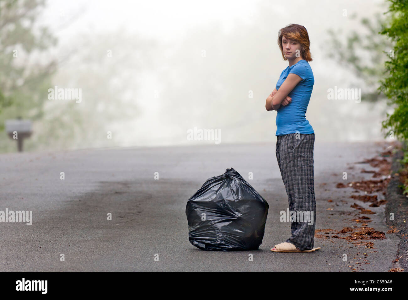 Teenage Girl waiting for garbage man Stock Photo - Alamy
