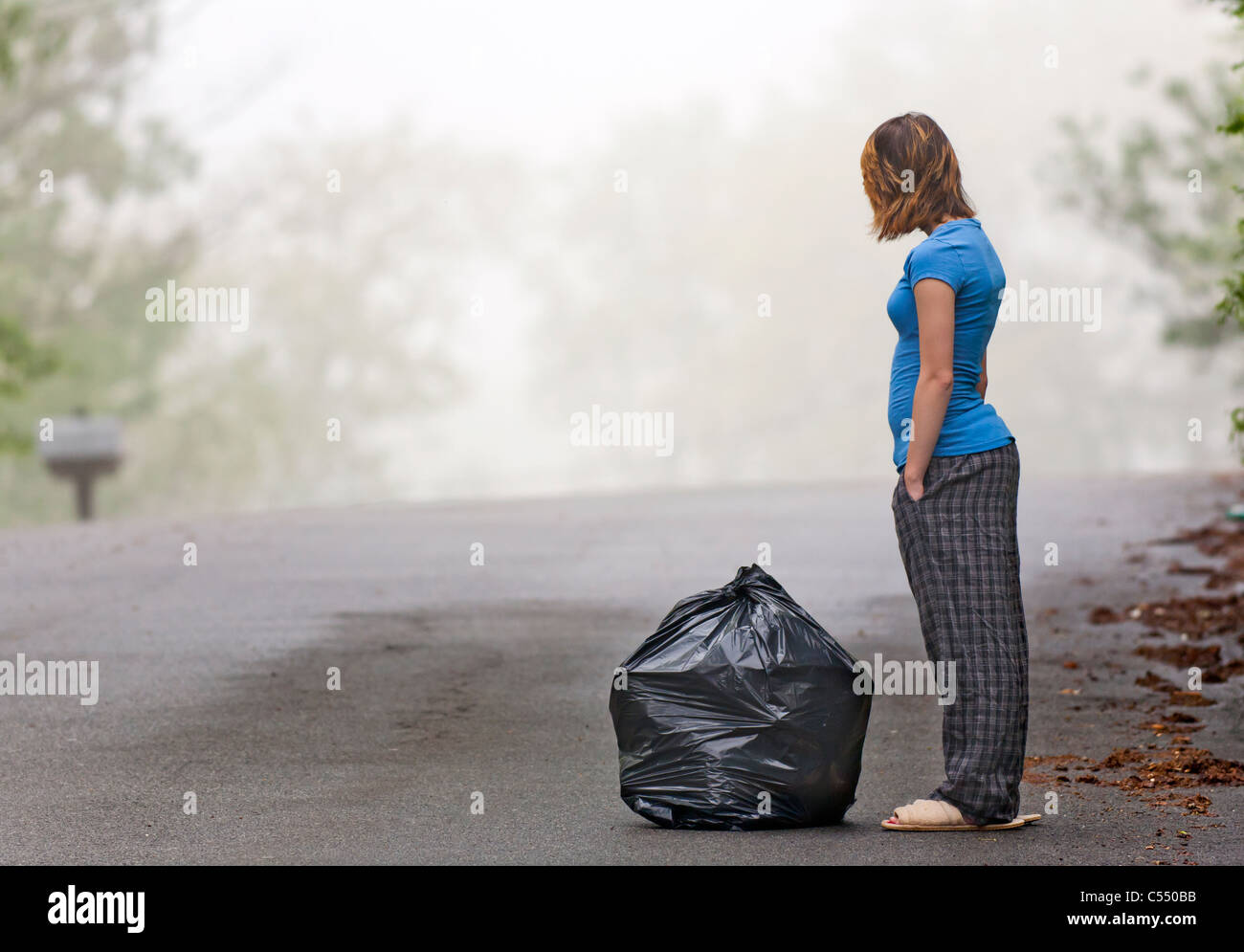 Teenage Girl waiting for garbage man Stock Photo - Alamy