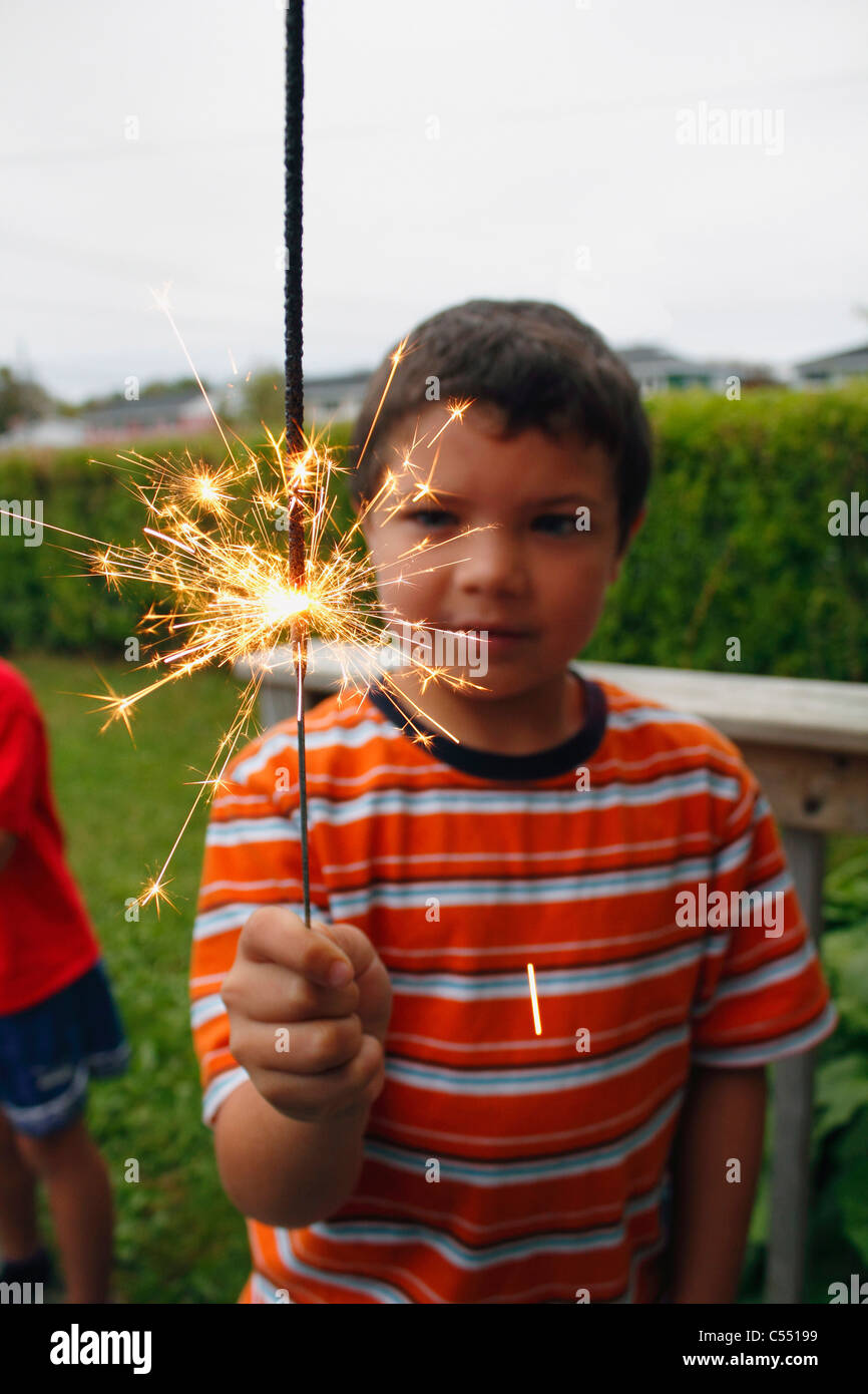 Boy holding a sparkler Stock Photo - Alamy