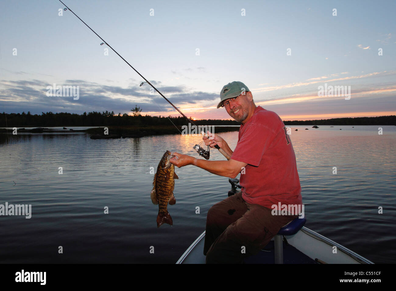 Mature man bass fishing in a lake Stock Photo - Alamy